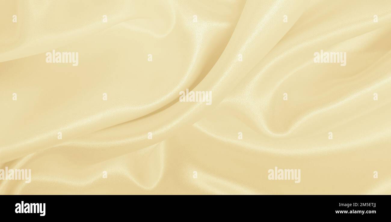 Smooth elegant golden silk or satin luxury cloth texture can use as ...