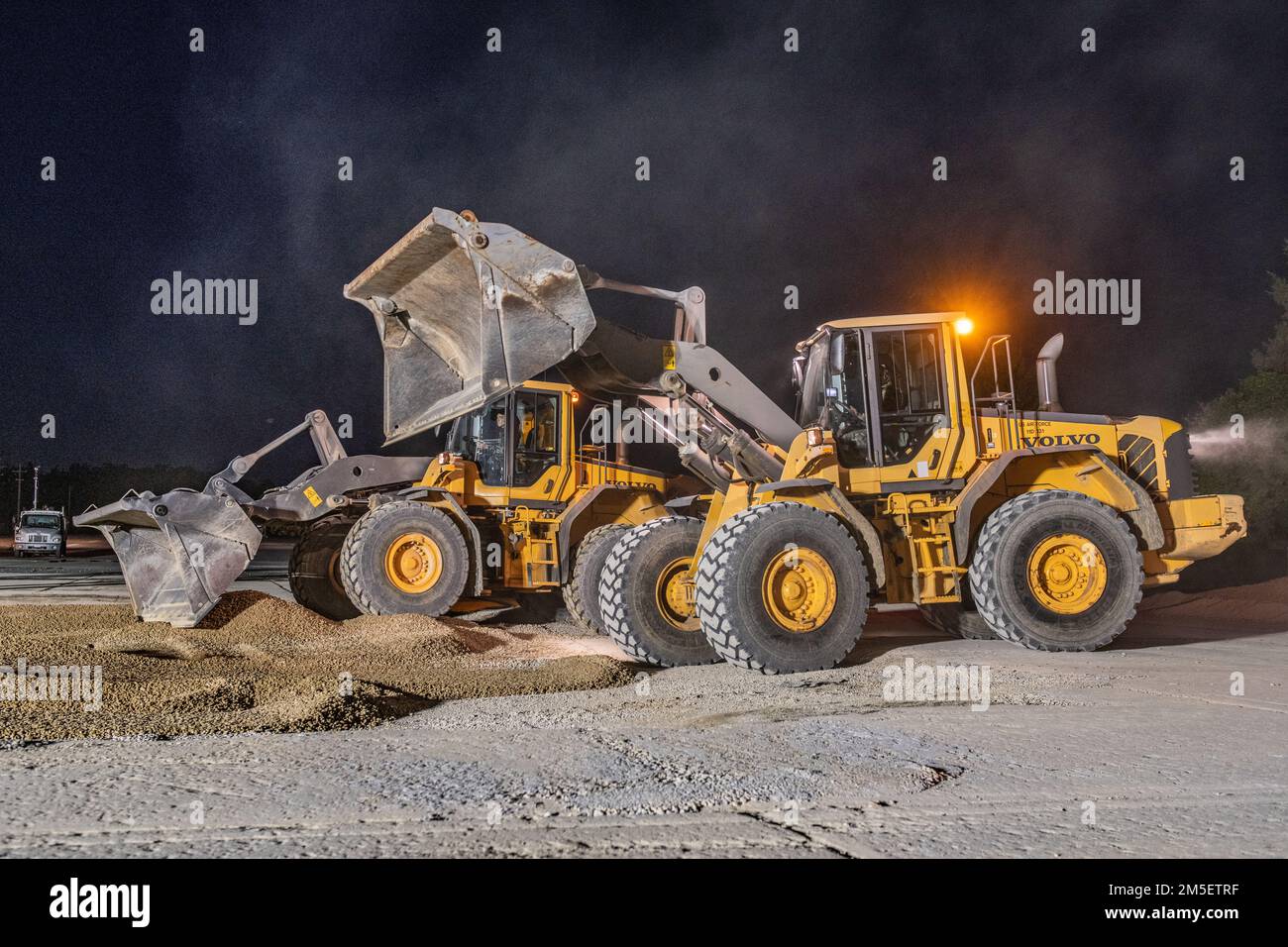 Two front-end loaders from the 18th Civil Engineer Squadron flatten and ...