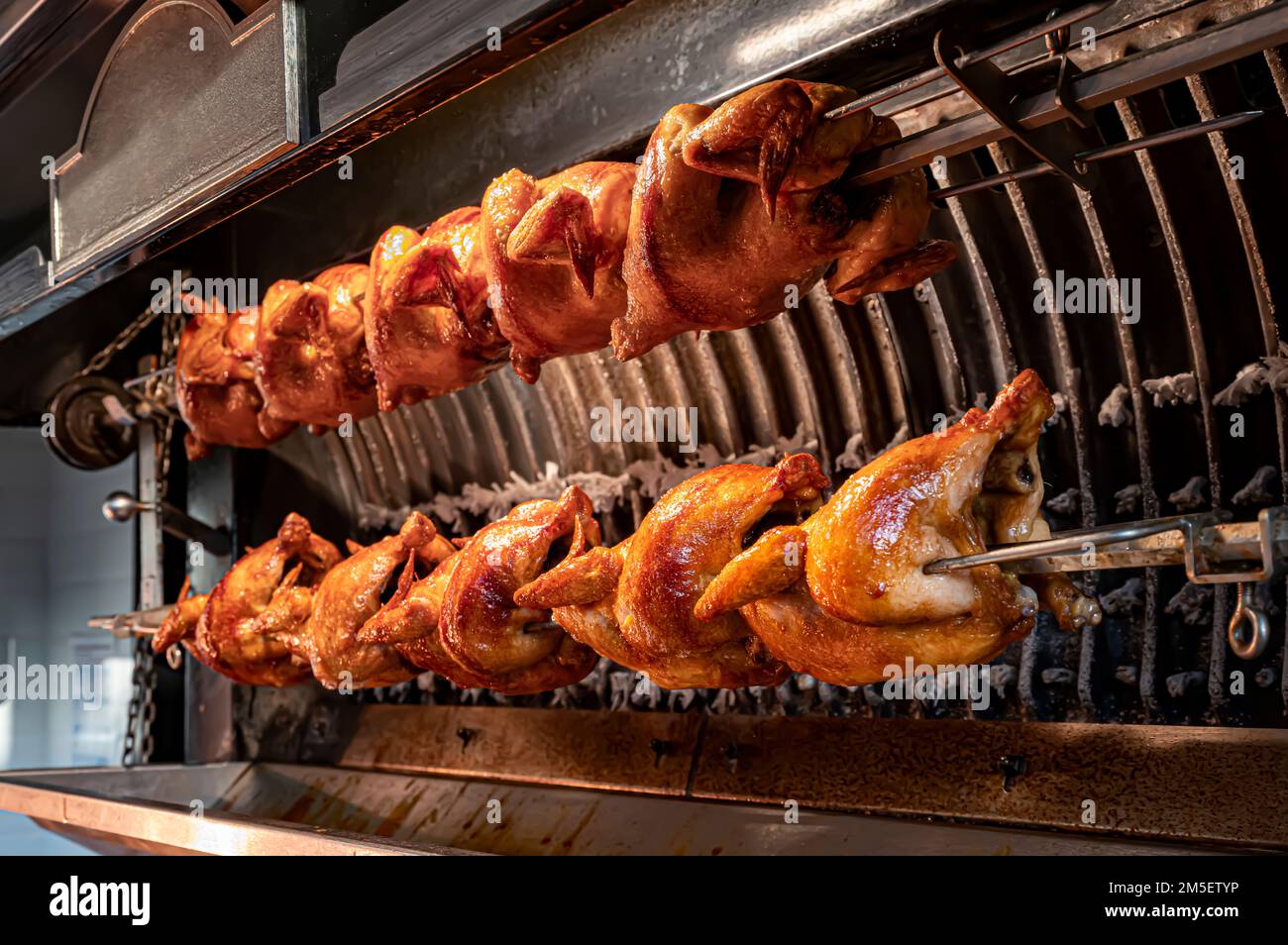 The whole chickens grilling process in the rotisserie machine Stock ...