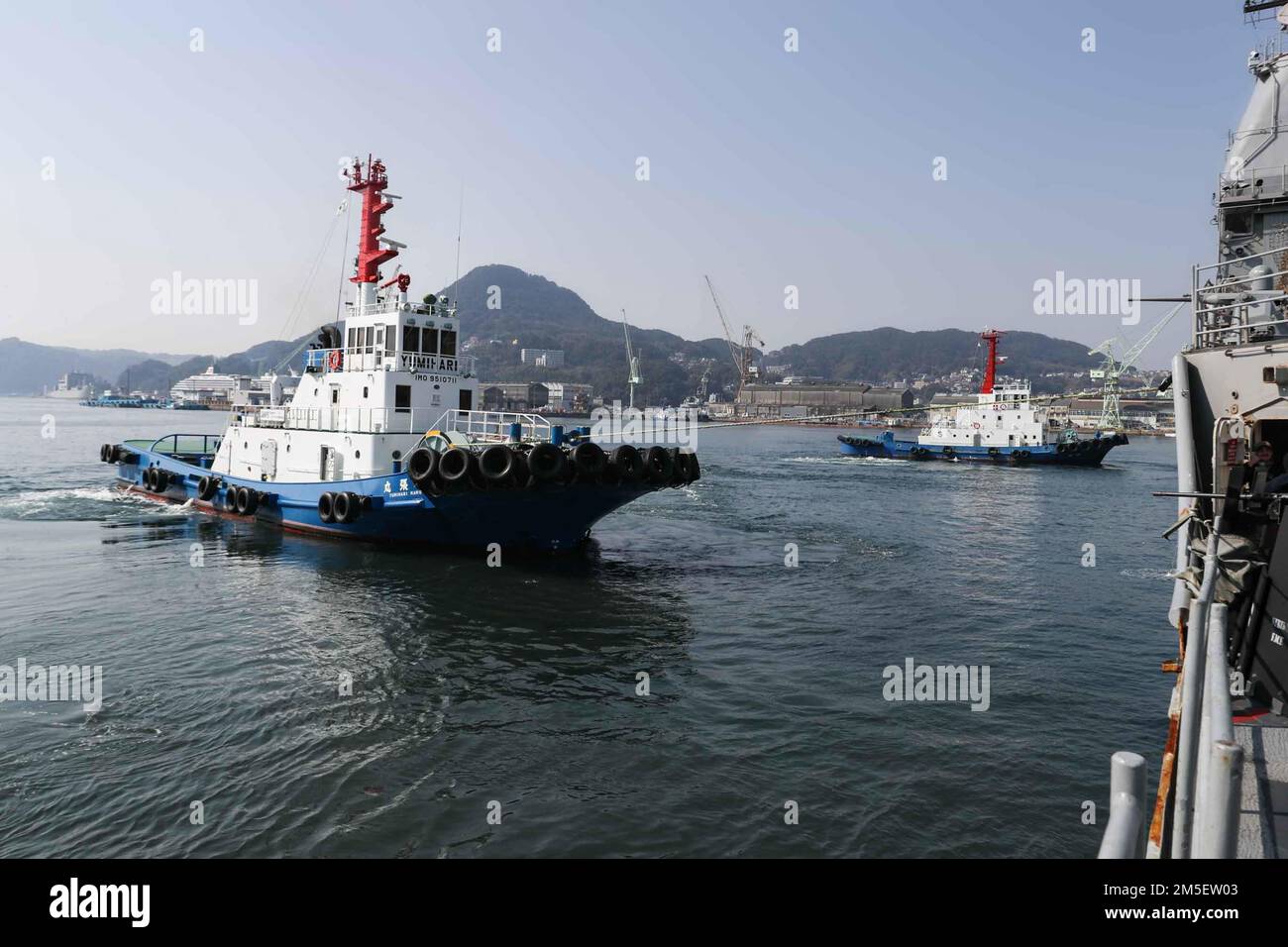 SASEBO, Japan (March 9, 2022) Japanese tug boats guides the Ticonderoga ...