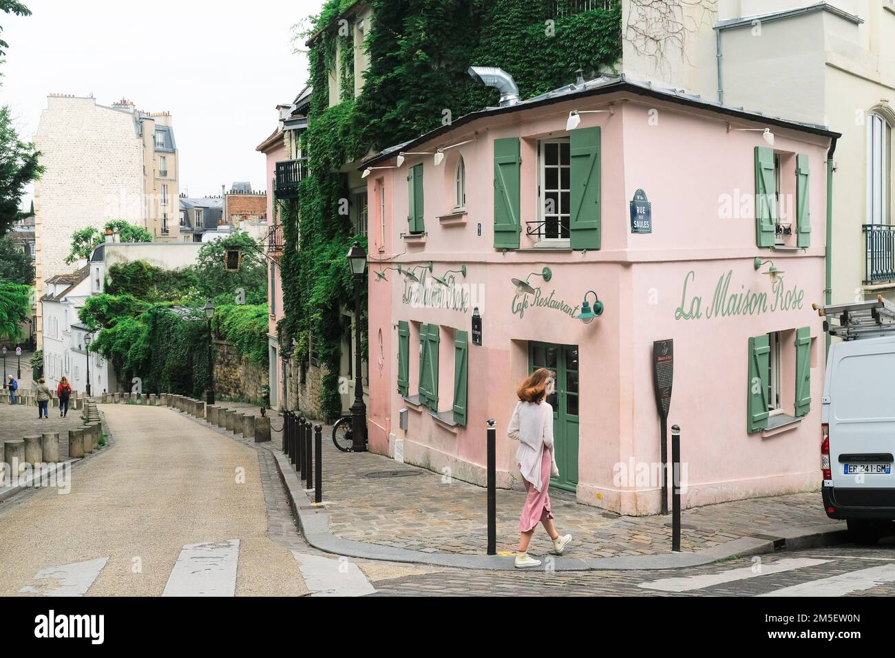 Paris, France - woman walks past La Maison Rose Cafe Restaurant in ...