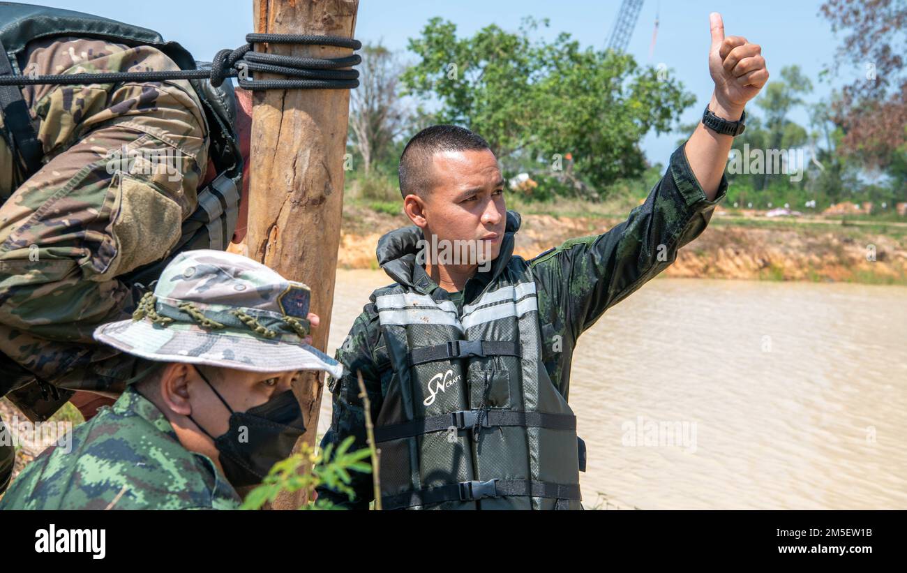 A Royal Thai Army soldier signals it’s safe to cross after securing his ...