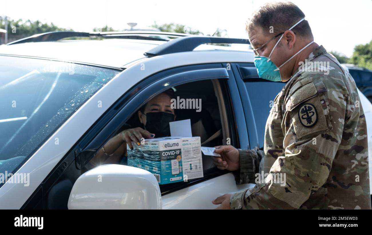 MAJ J. Aaron Matthews hands Ms. Romabella Ty-Arcangel her COVID-19 Test ...