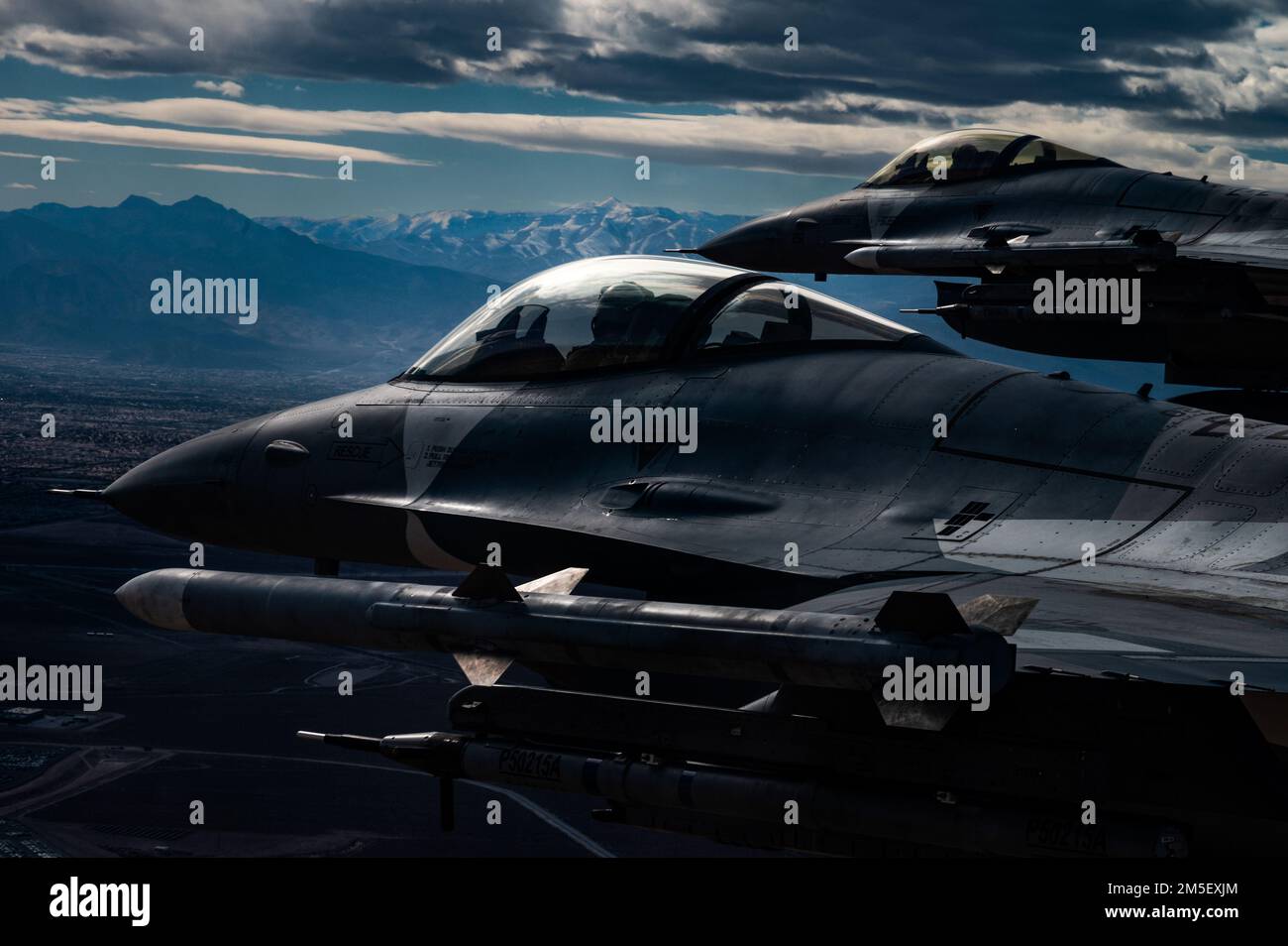 Two F-16 Fighting Falcons assigned to the 64th Aggressor Squadron fly ...