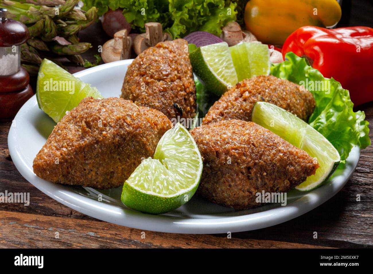 Fried kibble with lemon, Quibe food Stock Photo - Alamy