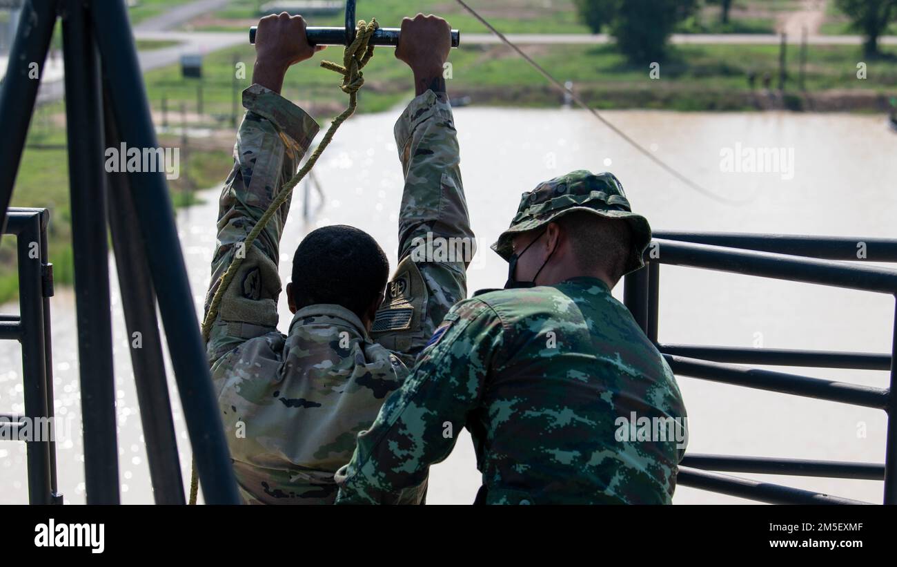 A Royal Thai Army soldier briefs Staff Sgt. Jamon Robinson, Alpha ...
