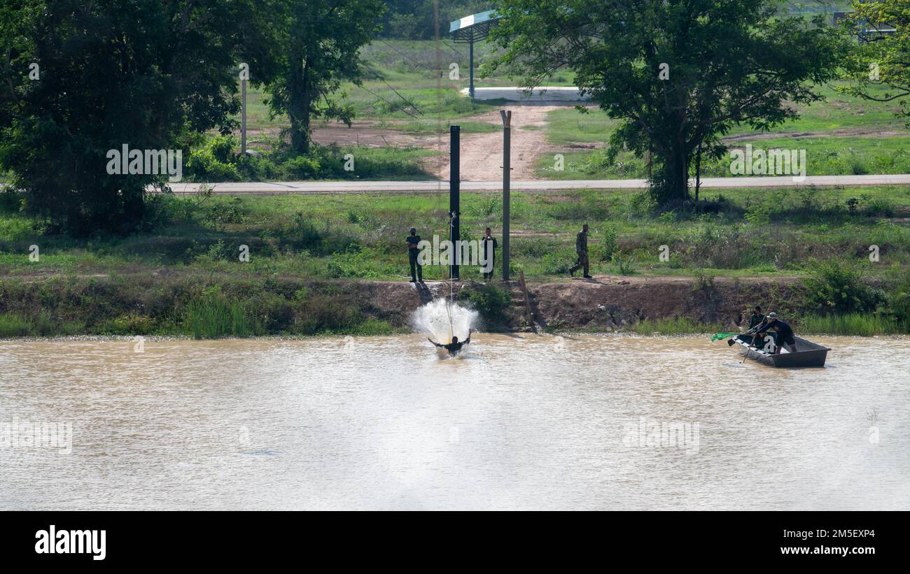 A soldier hits the water after going down a zip-line as part of a ...