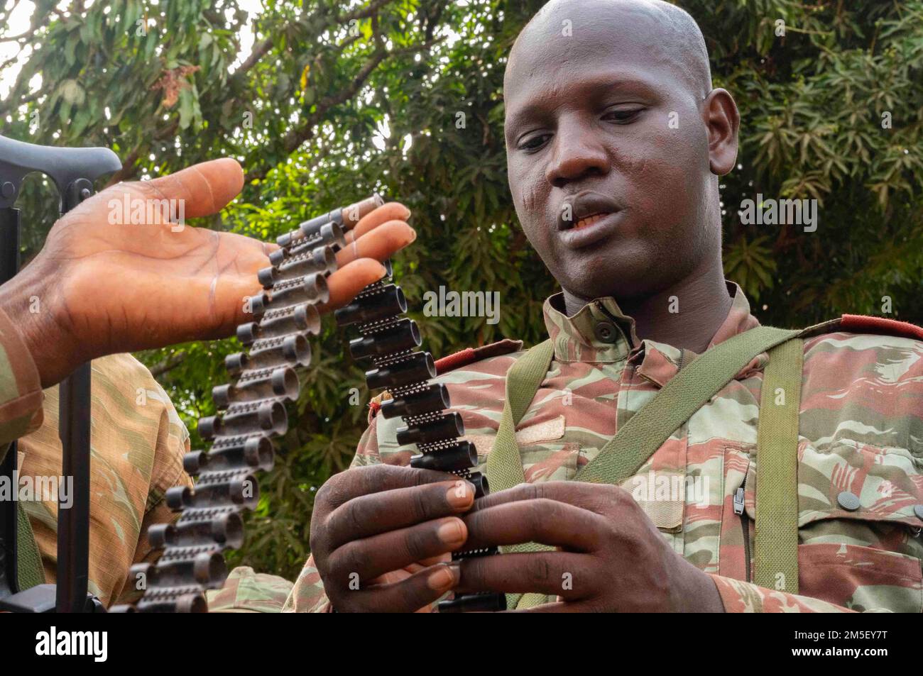 A soldier from the Benin 1st Commando Parachute Battalion counts the ...