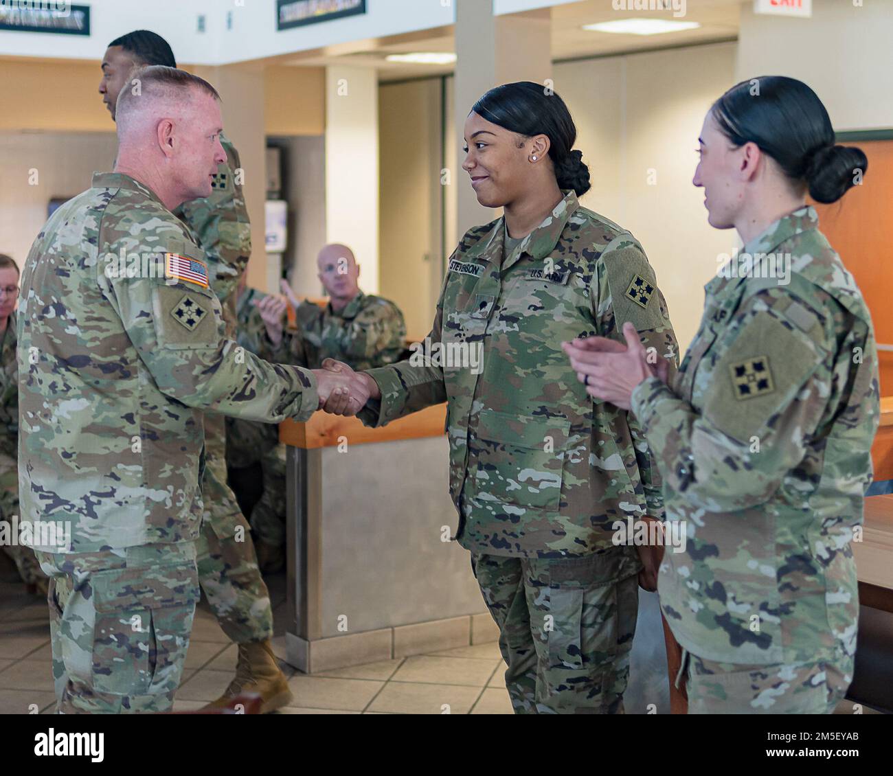 Spc. Andrea Stevenson, center, an Army food service specialist assigned ...