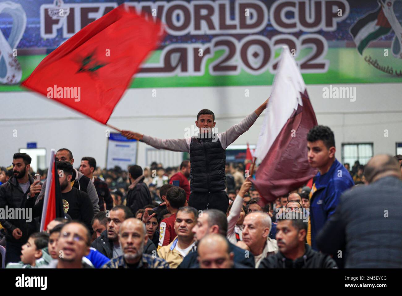 Palestinian football fans lift the national and Moroccan flags as they ...