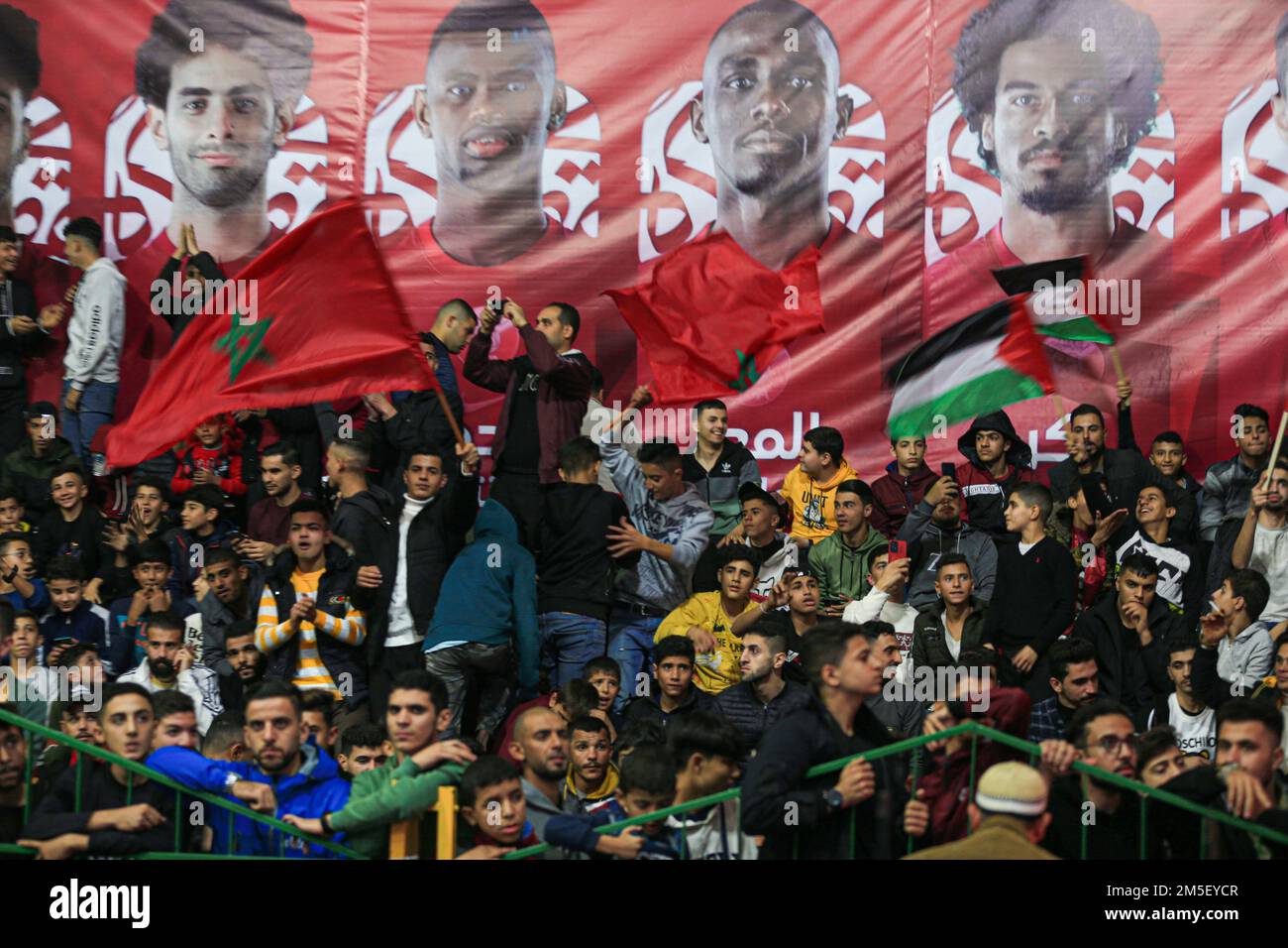 Palestinian football fans lift the national and Moroccan flags as they ...
