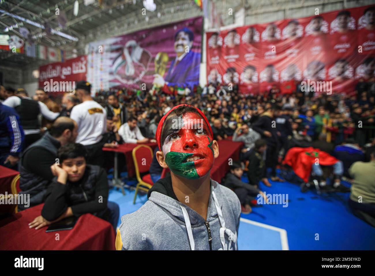 Palestinian football fans lift the national and Moroccan flags as they ...