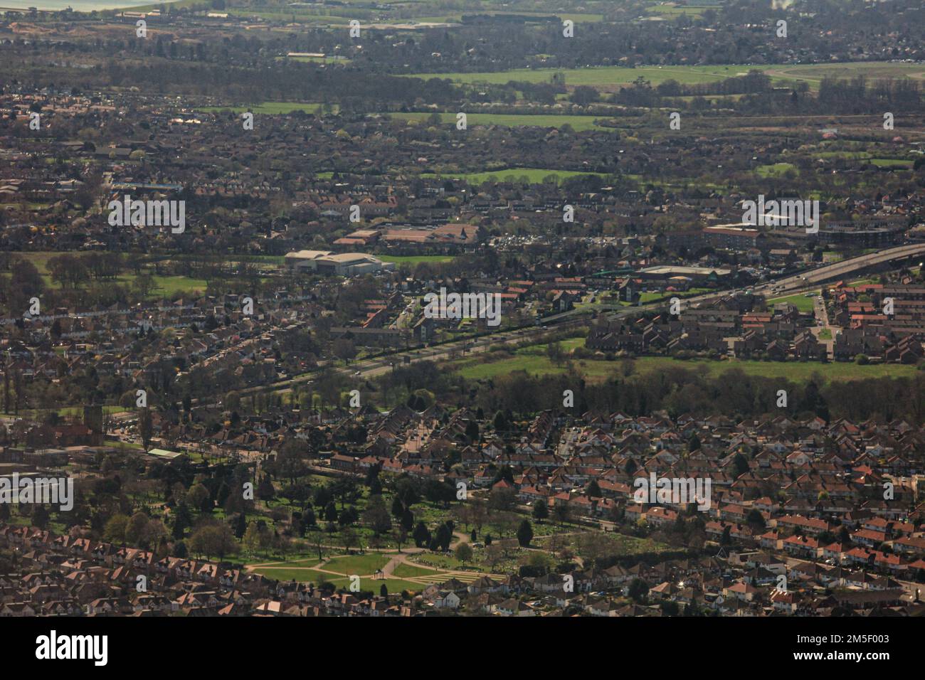 An aerial shot of green fields, buildings and roads during daytime from ...