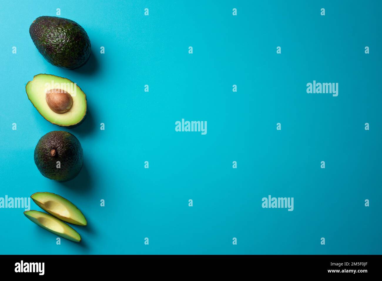 Fresh avocados on a blue background. Banner with free space for text ...