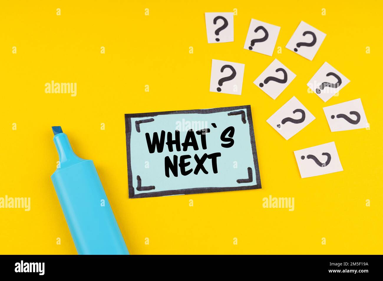 Business concept. On the yellow surface lies a blue marker, question ...