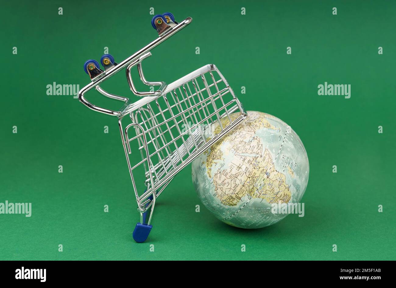 The globe is enclosed in an inverted basket on a green background ...