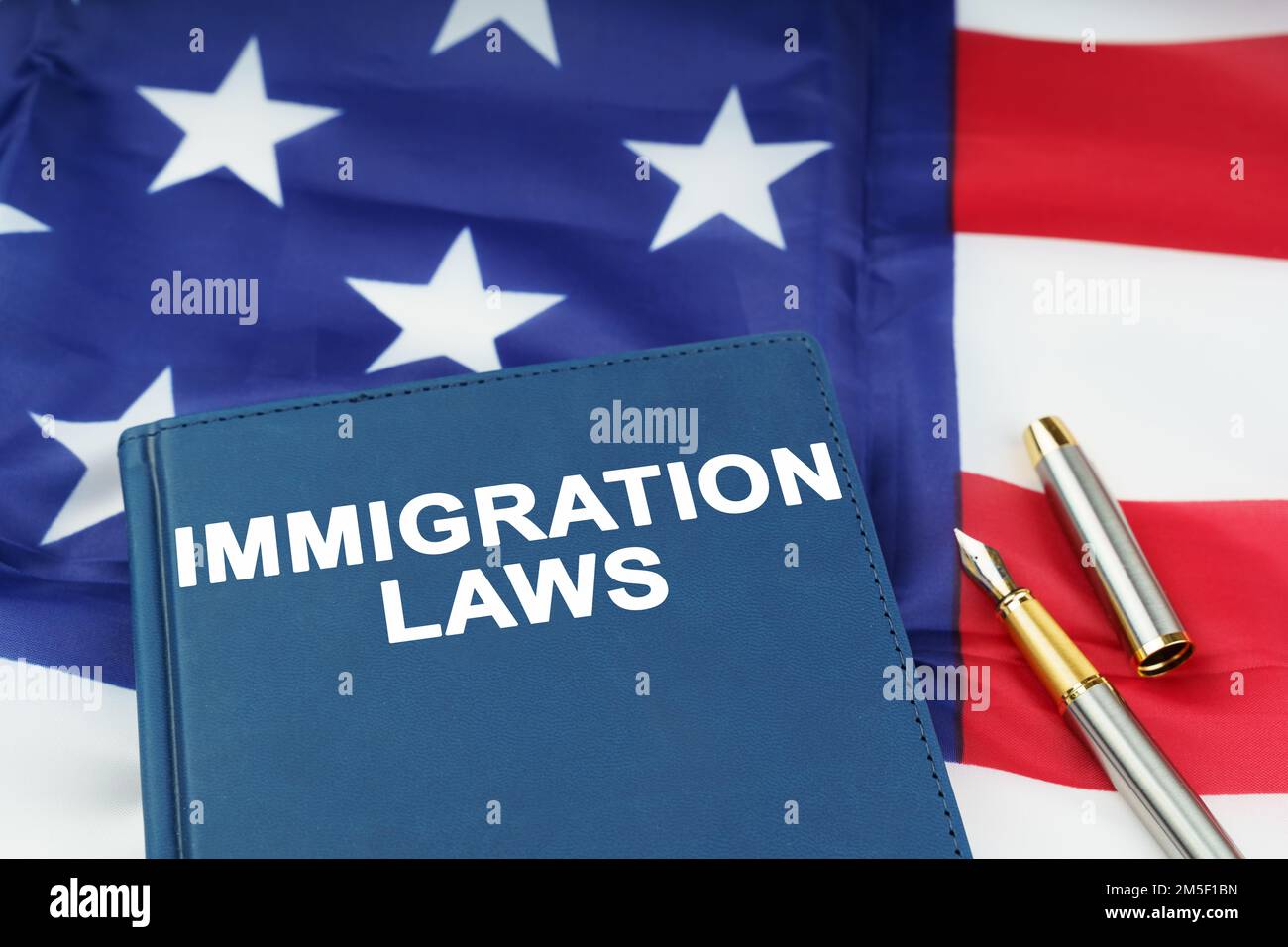 Law concept. On the US flag lies a pen and a book with the inscription ...
