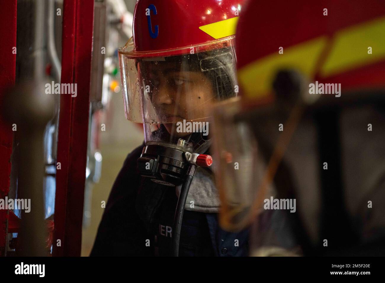 Recruits spray a hose into a simulated fire during a firefighting ...