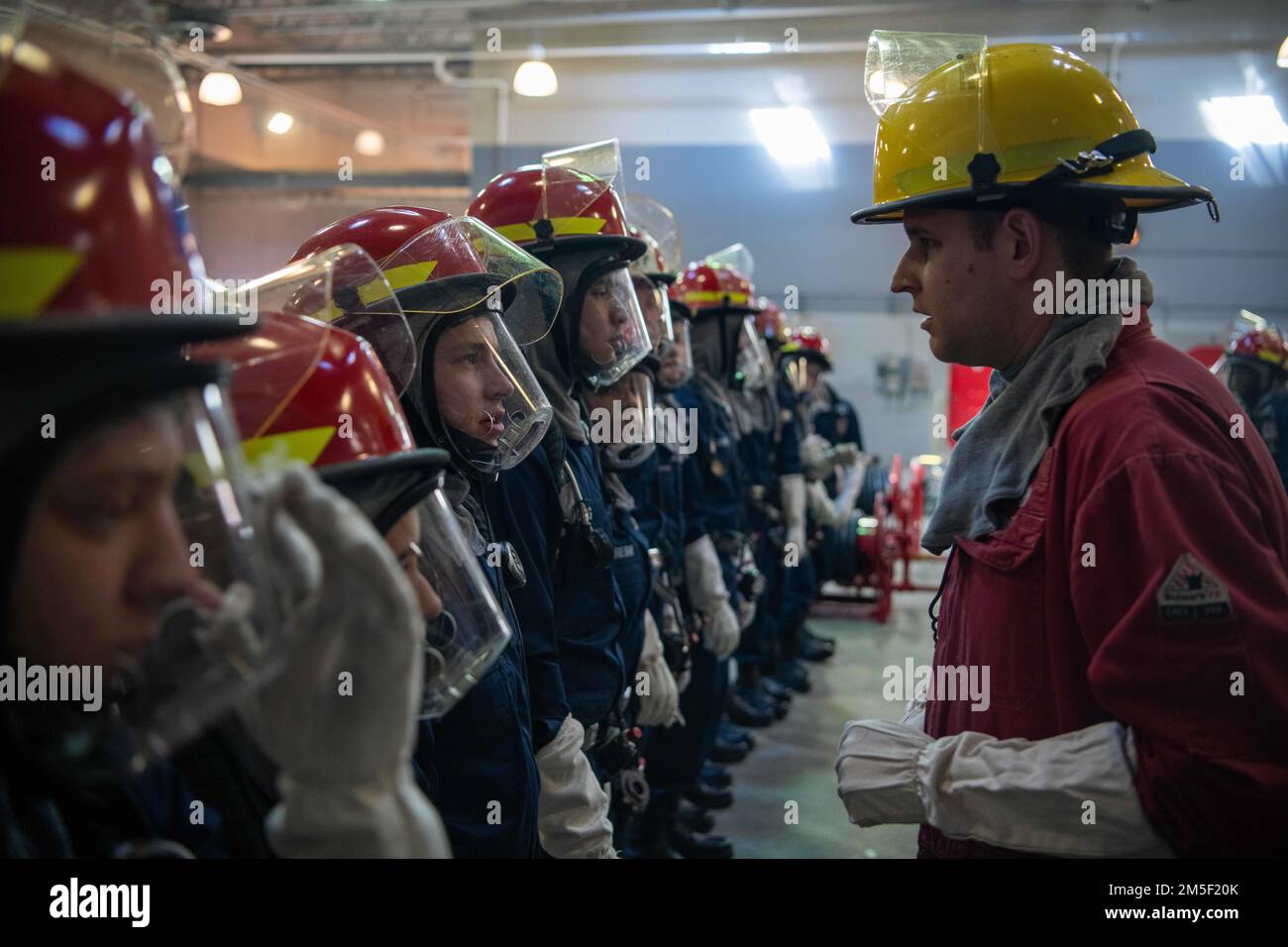 An instructor checks a recruits gear before a firefighting training ...