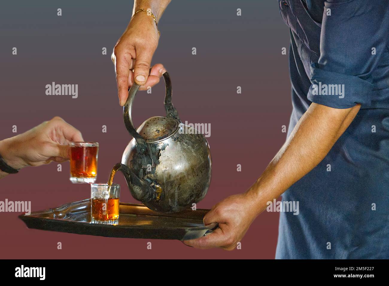 Body part of a man serving tea in an arabian land Stock Photo - Alamy
