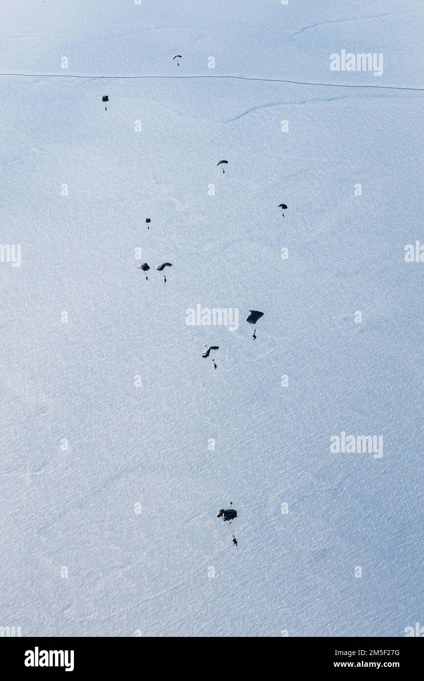 Naval Special Warfare members deploy their parachutes while performing ...