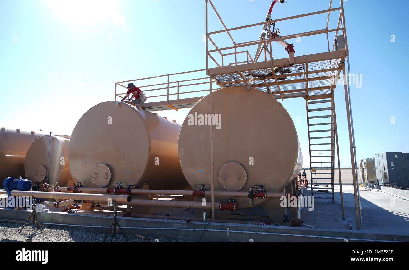 Levi Mello, a service technician with Perimeter Solutions, tightens a ...