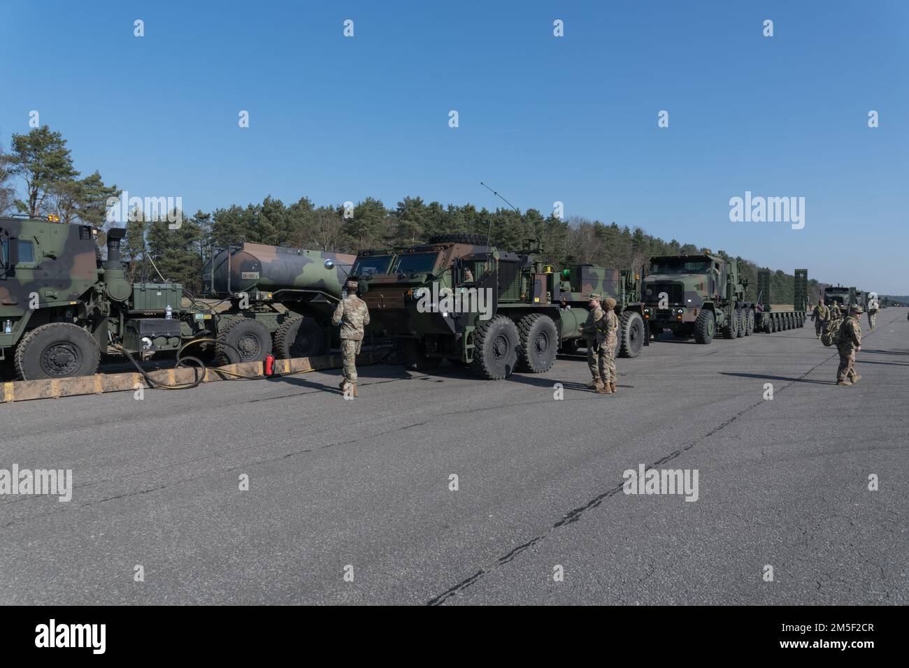 Heavy U.S. Army vehicles line up for refueling before a convoy, on the ...