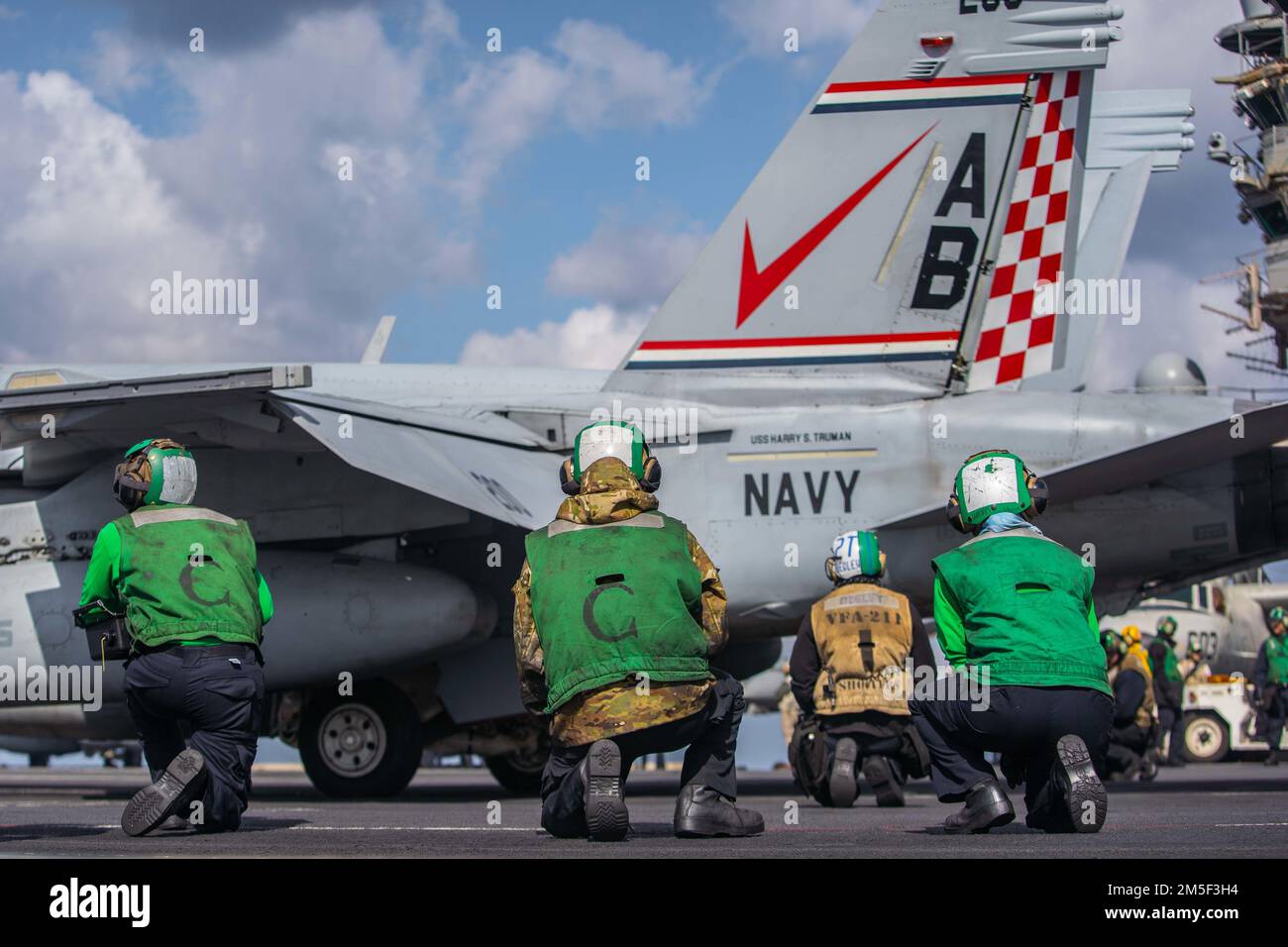 220310-N-BF800-1001 IONIAN SEA (Mar. 10, 2022) Sailors kneel as an F/A ...