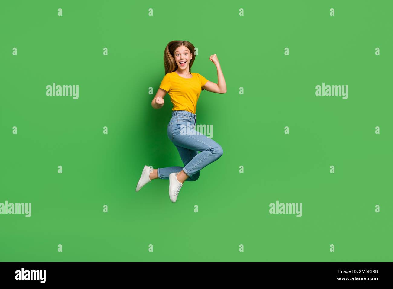 Full body photo of overjoyed carefree girl jumping raise fists luck ...