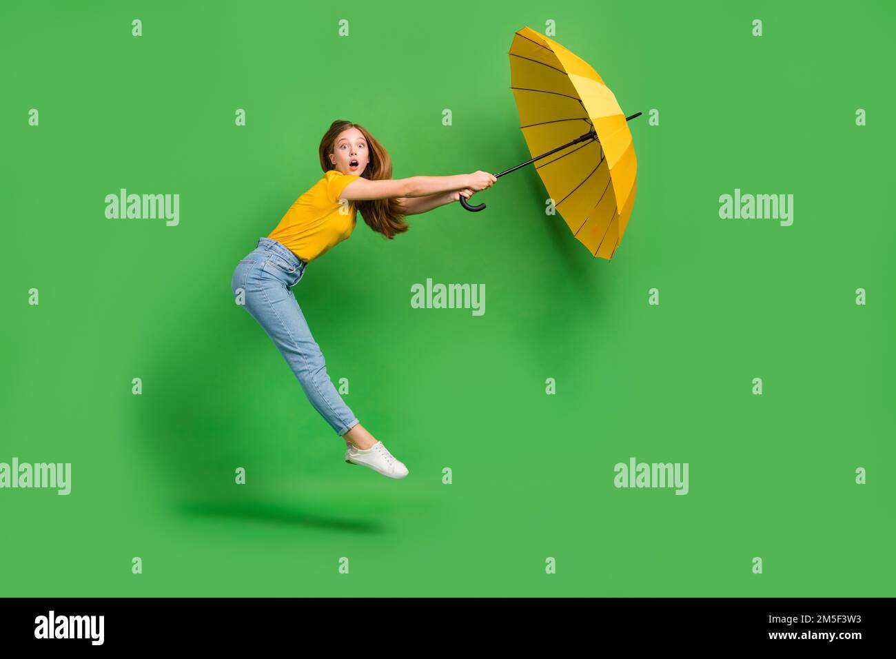 Full body profile photo of impressed girl jump hold umbrella strong ...