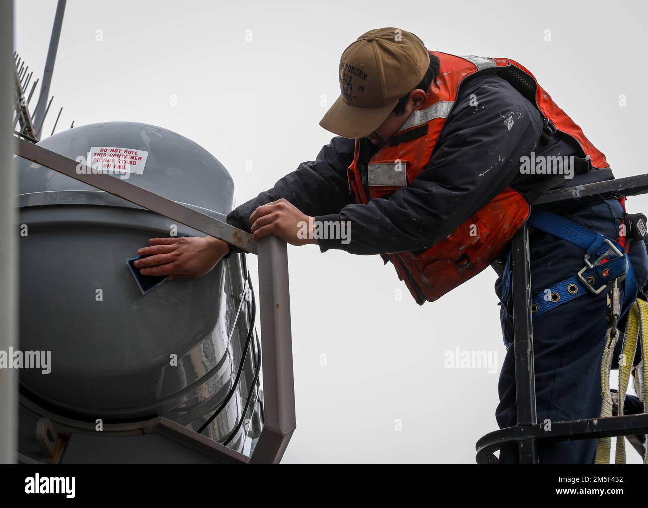 NORFOLK, Va. (Mar. 10, 2022) – Seaman Julian Lopez performs maintenance ...