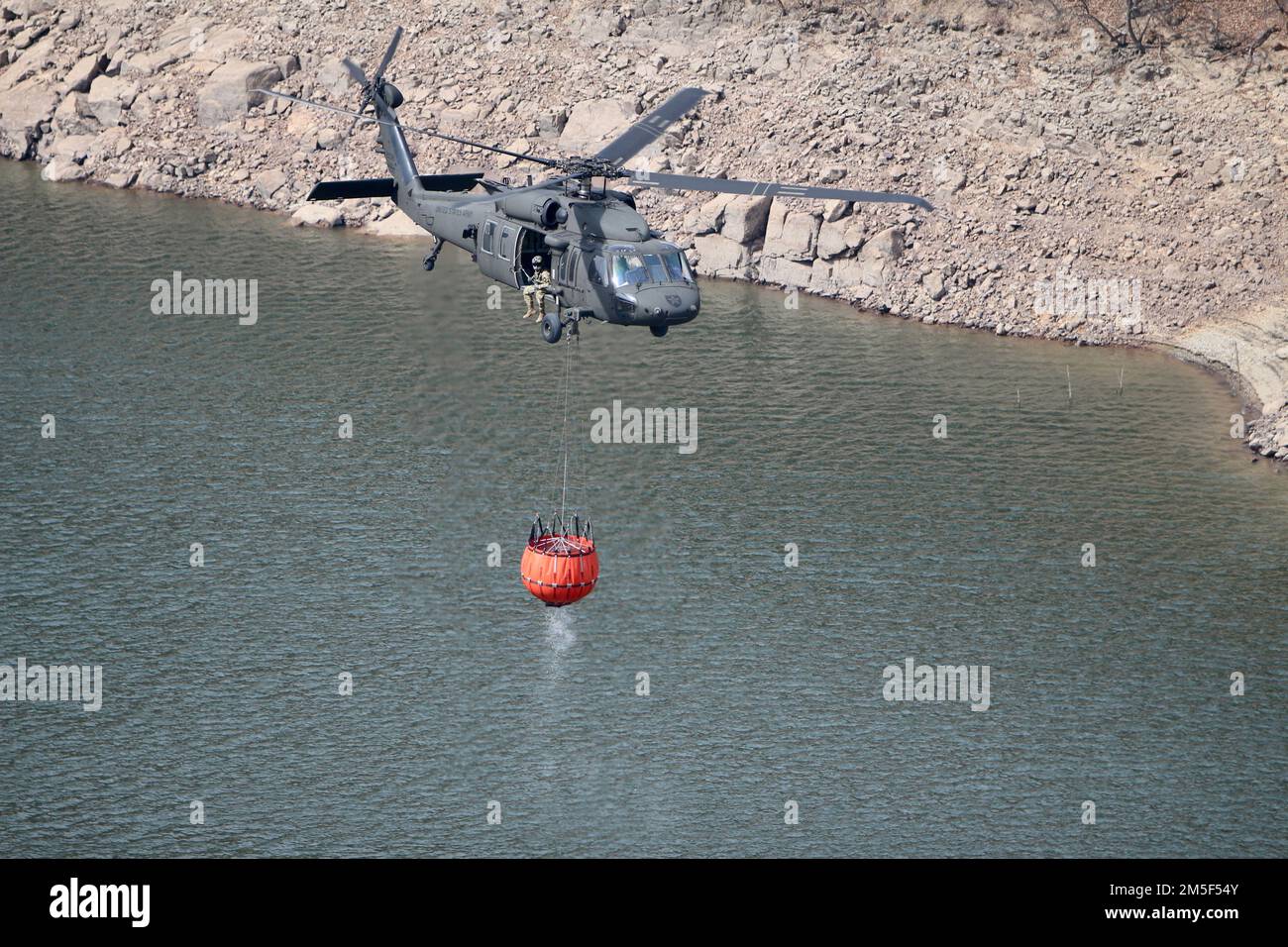 A UH-60 Blackhawk helicopter retrieves water from Kach’ang-josuji water ...