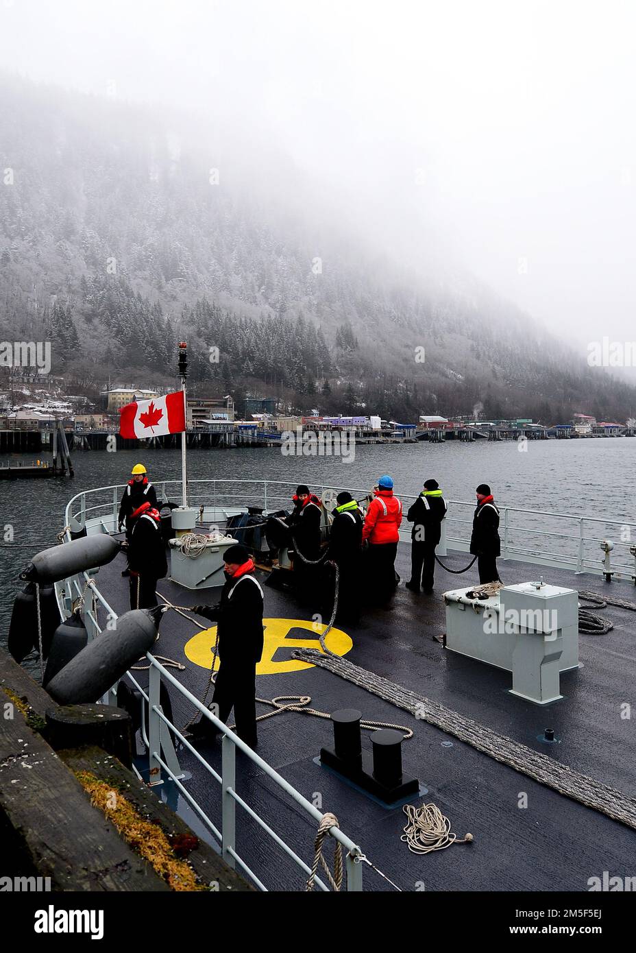 Royal Canadian Navy Sailors place fenders over the side of the Kingston ...