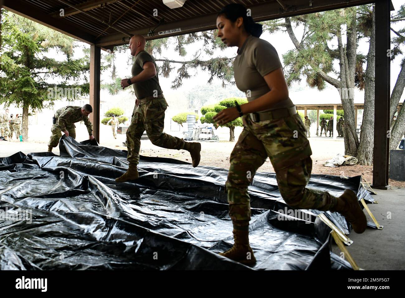 An In Place Patient Decon (IPPD) team from the 8th Medical Group rush ...