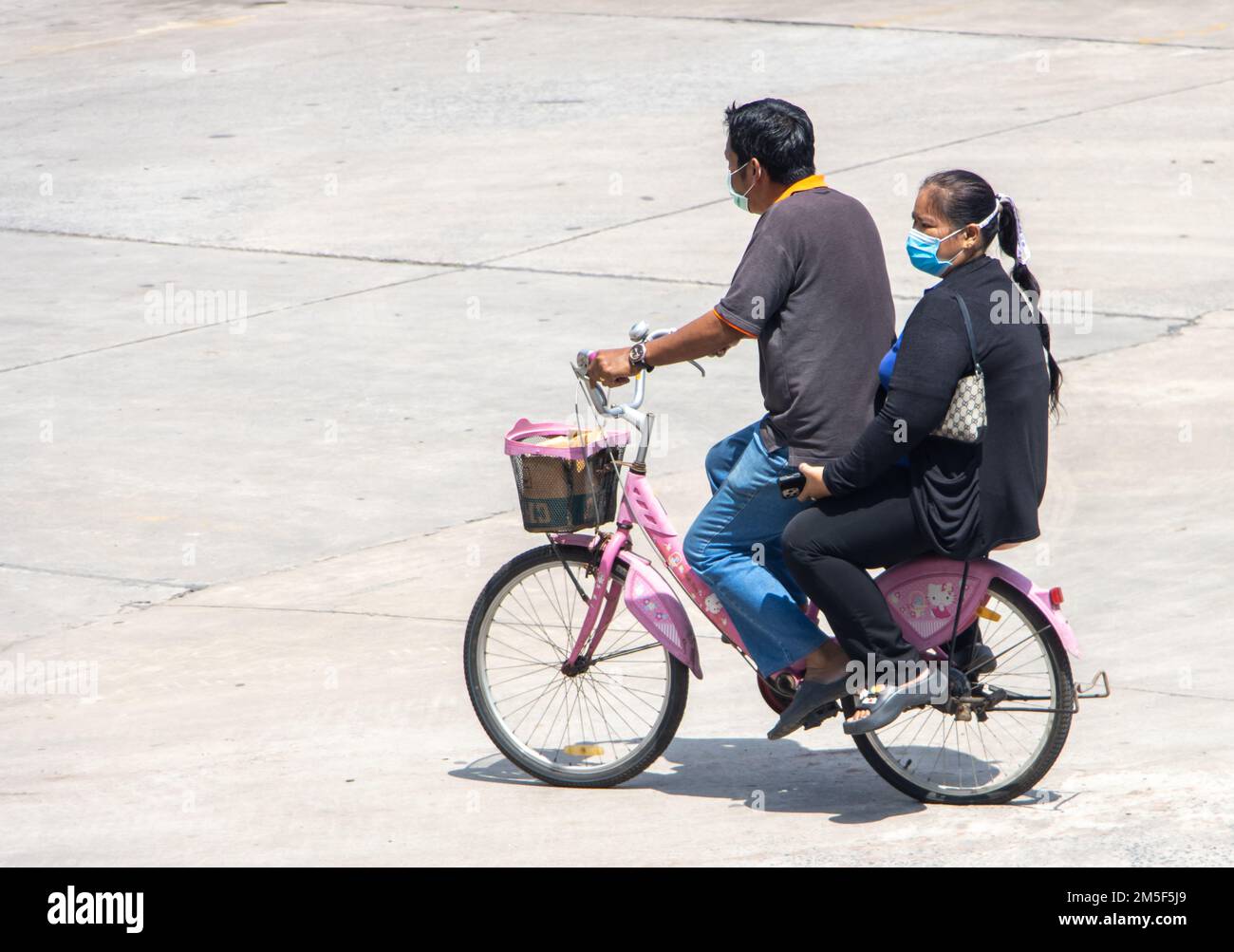 SAMUT PRAKAN, THAILAND, OCT 12 2022, An elderly couple rides together on one bike Stock Photo ...