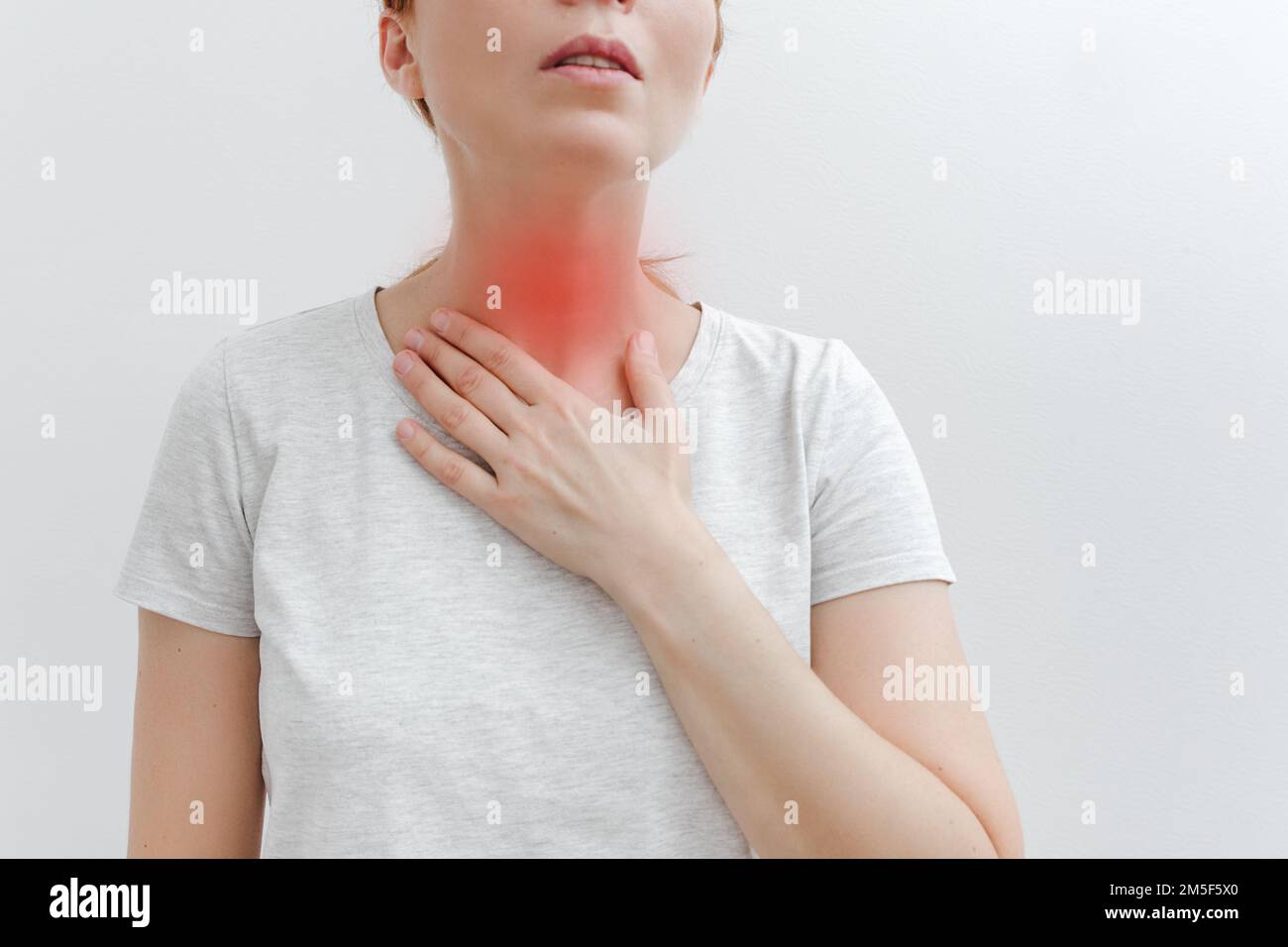 Young woman with pain in throat, toothache. Red mark. Women touches the ...