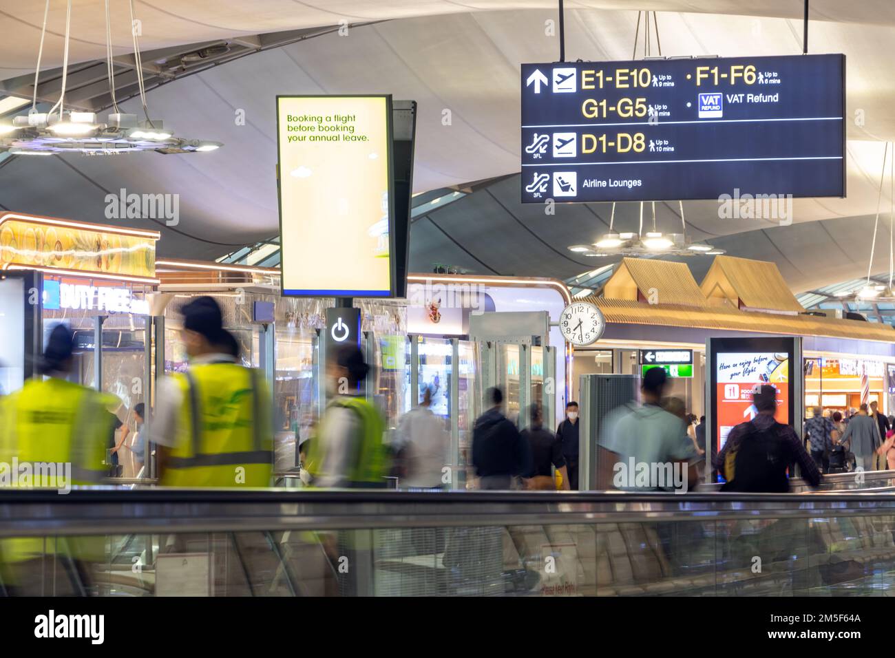 People ride on a moving walkway at the international airport Stock ...