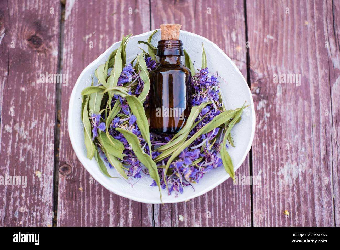 Dry herbal tea from fireweed flowers in a small clay bowl with brown ...