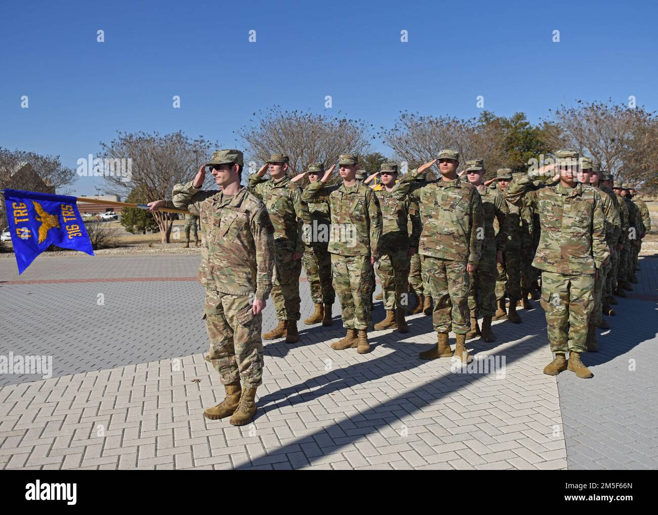 Service members assigned to the 316th Training Squadron salute as the ...