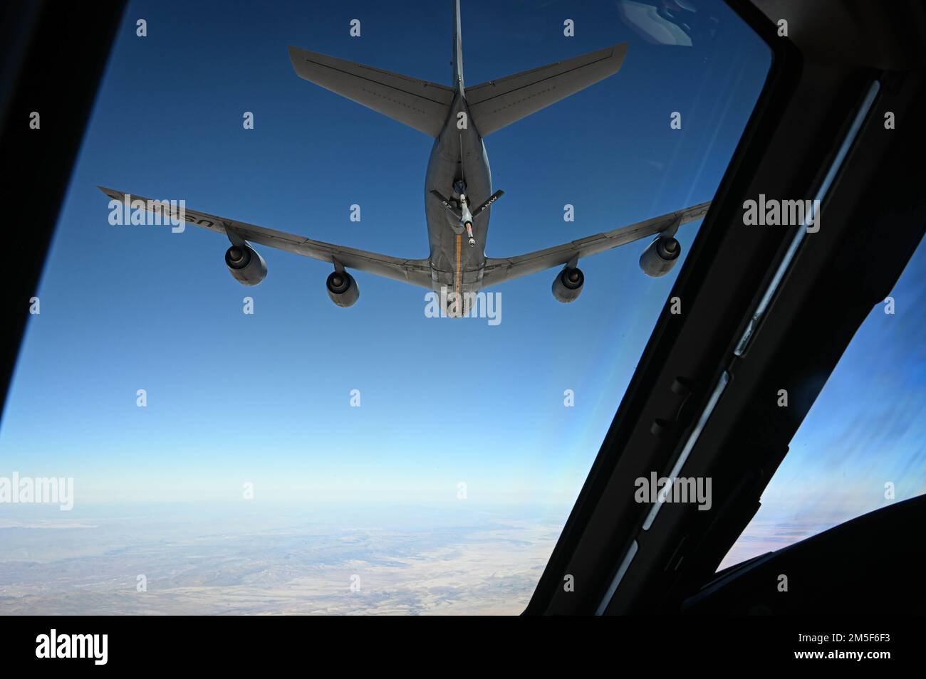 A KC-135 Stratotanker begins the air refueling process for a KC-46 ...