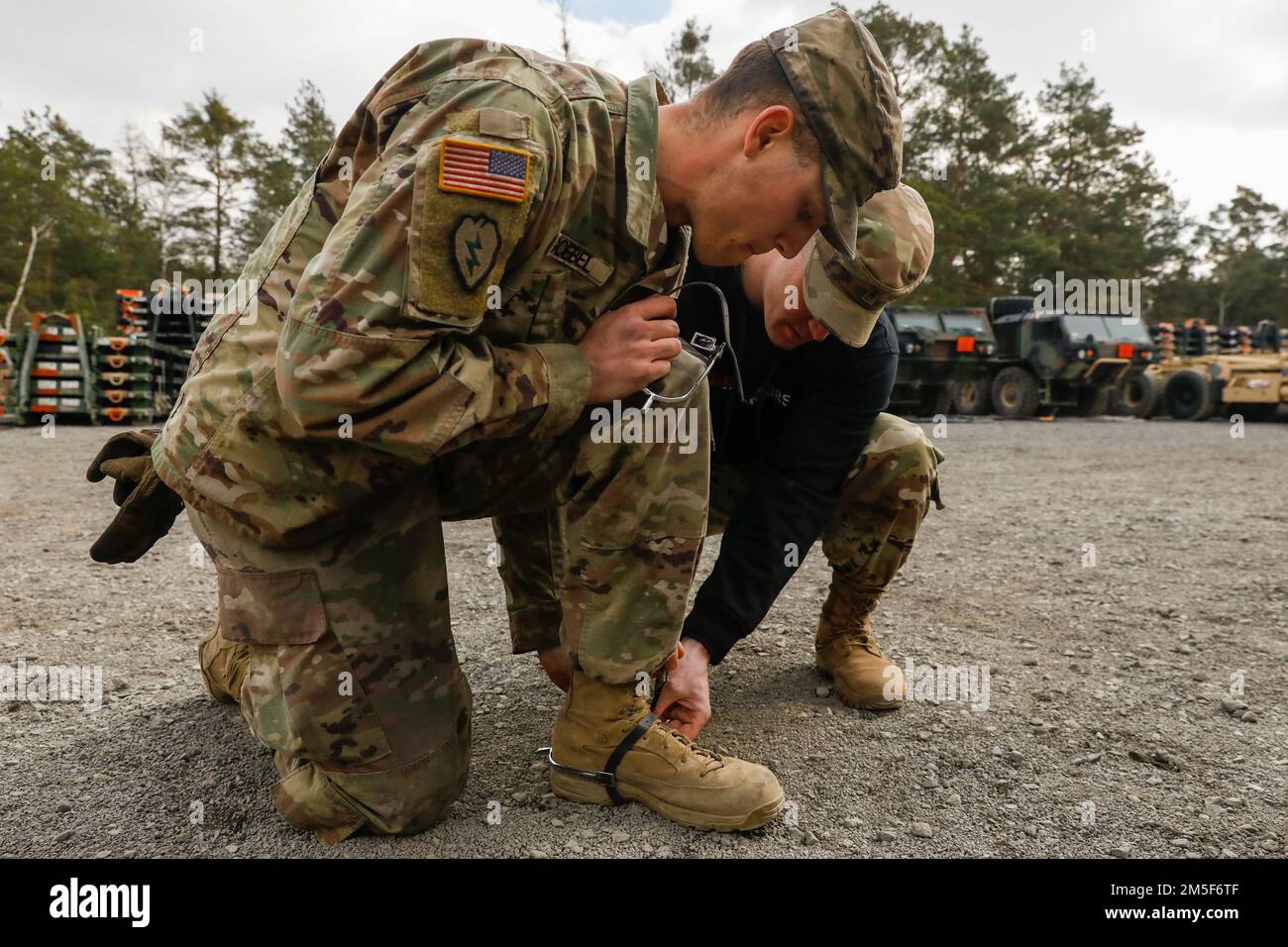 U.S. Army Chief Warrant Officer 2 Andrew Goebel assists his brother, U ...