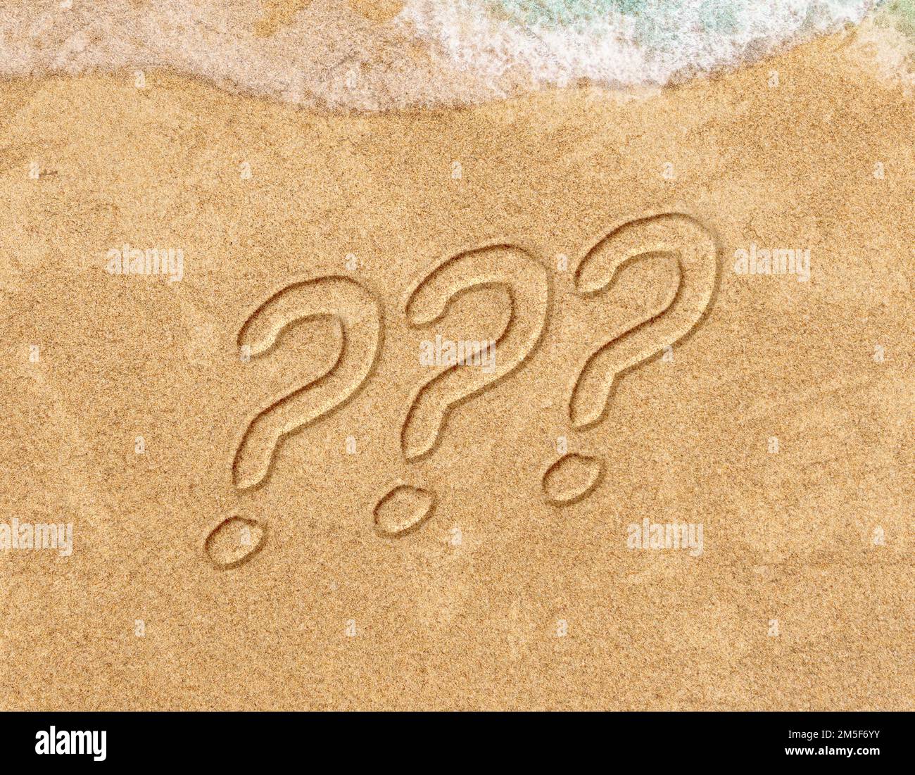 question mark sign handwritten in sand beach Stock Photo - Alamy