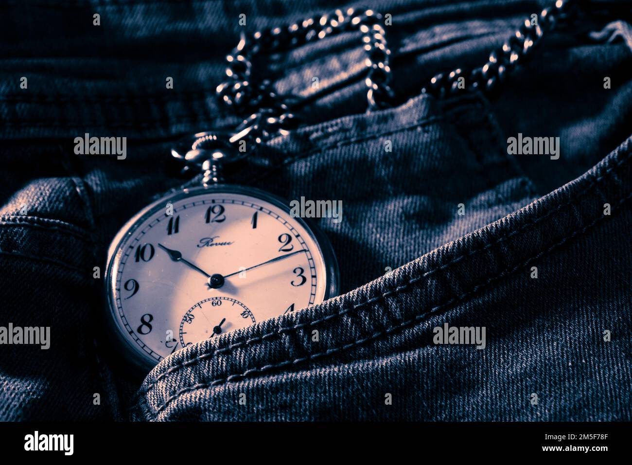 pocket watch on a blue jeans Stock Photo - Alamy