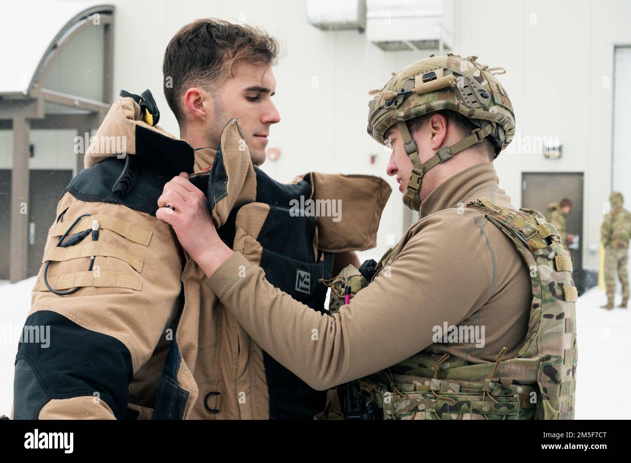 U.S. Air Force Senior Airman Richard Syverson (right), assists Tech ...