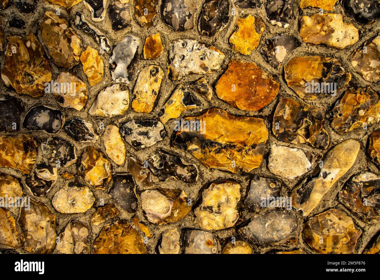 Hard light showing the strong textures in a stone wall and pointing ...