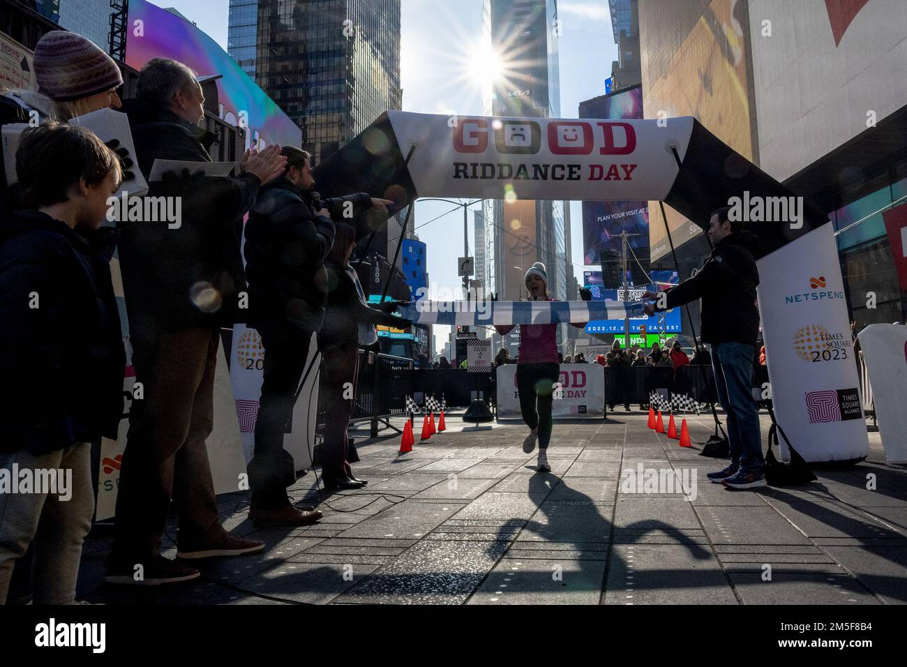 A woman races through the obstacle finish line as she says good ...