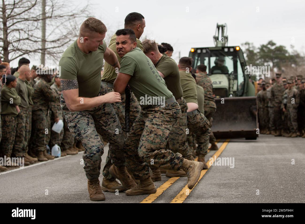 U.S. Marines work together during the backhoe loader pull event at ...