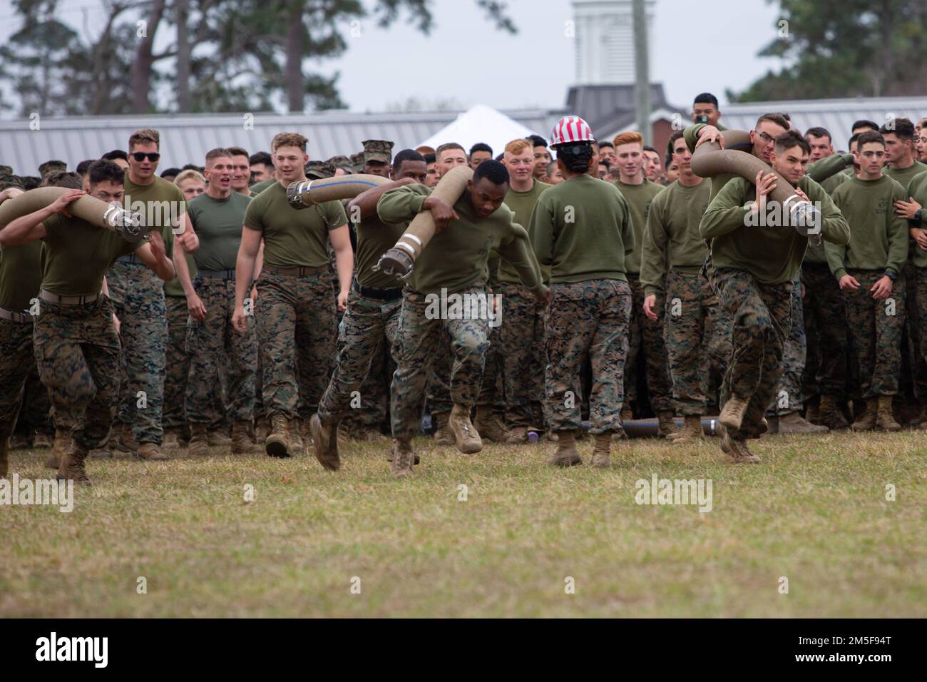 U.S. Marines compete against each other during the water hose relay at ...