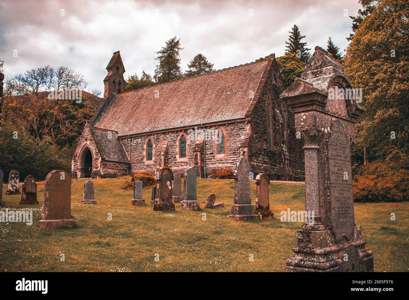 The cemetery of Balquhidder Parish church on a cloudy day in ...