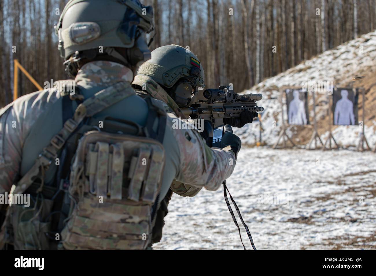 A Lithuanian Special Forces member sights his target while waiting for ...